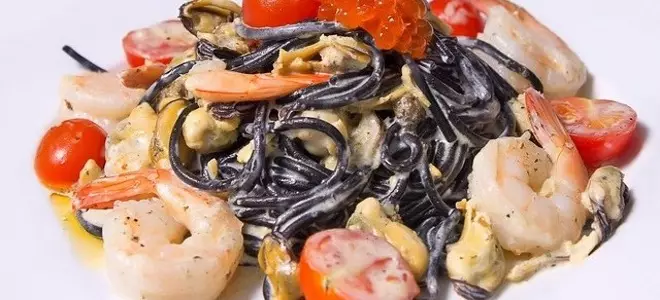 Black spaghetti with seafood in creamy sauce