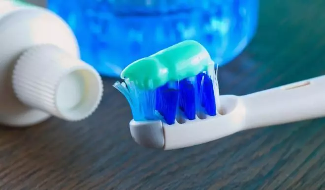 Using a large amount of toothpaste